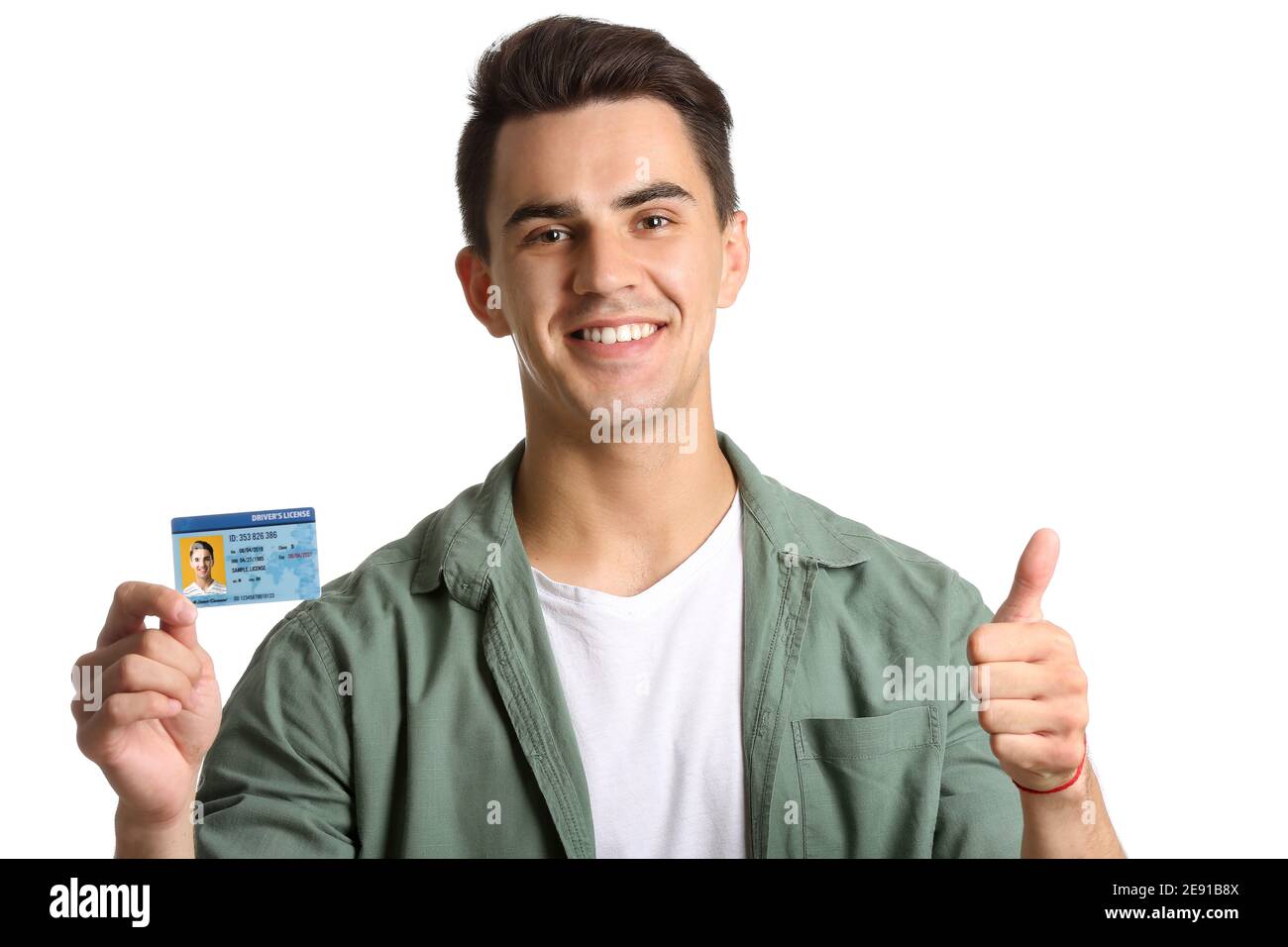 Young man with driving license on white background Stock Photo - Alamy