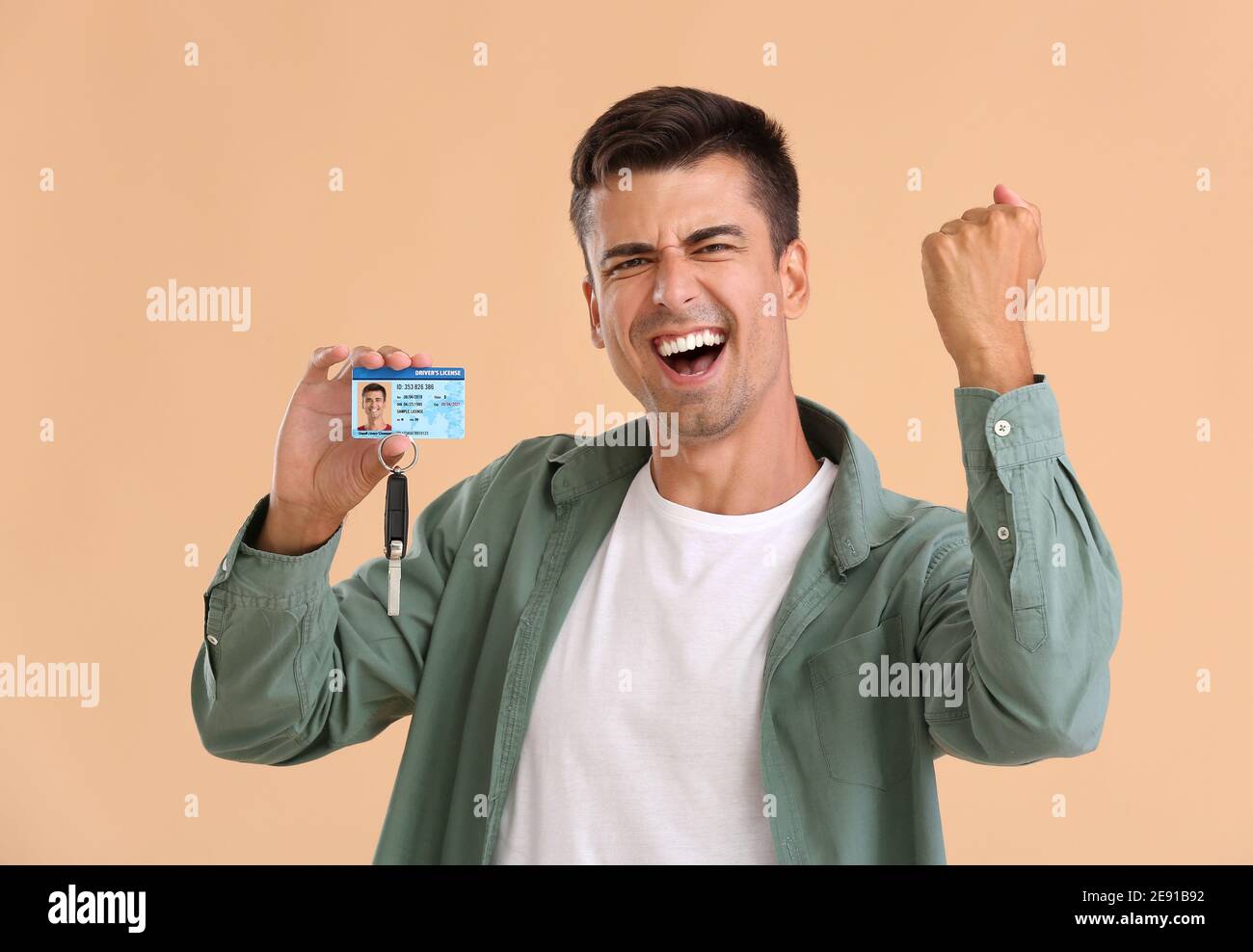 Happy man with driving license on color background Stock Photo - Alamy