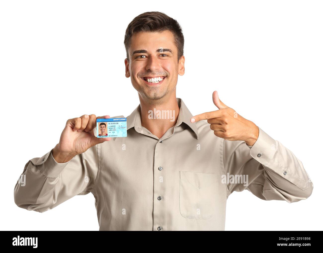 Happy young man with driving license on white background Stock Photo ...