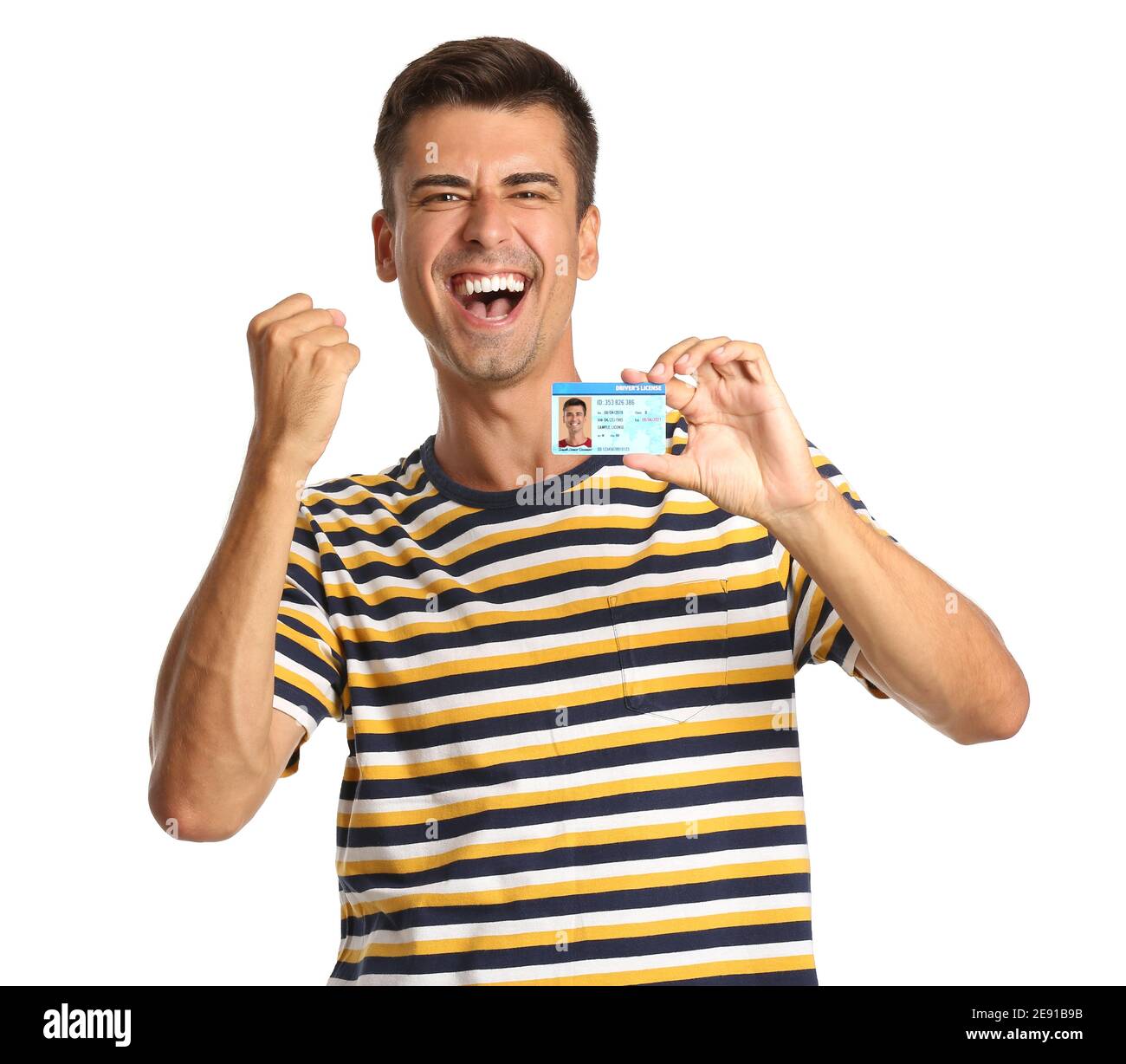 Happy young man with driving license on white background Stock Photo ...