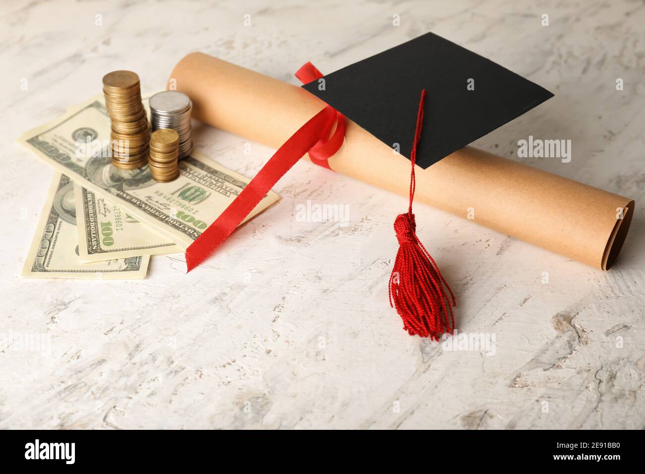 Diploma with graduation hat and money on light background Stock Photo ...