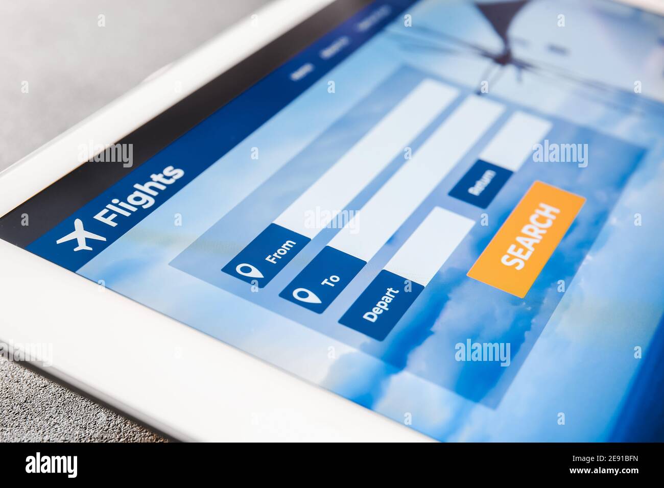 Open page of online booking service on screen of tablet computer ...