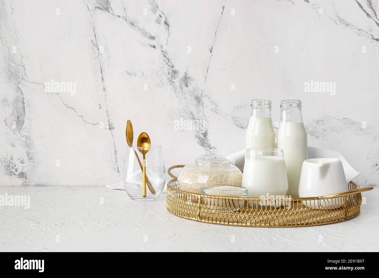 Tray with healthy rice milk on white background Stock Photo - Alamy