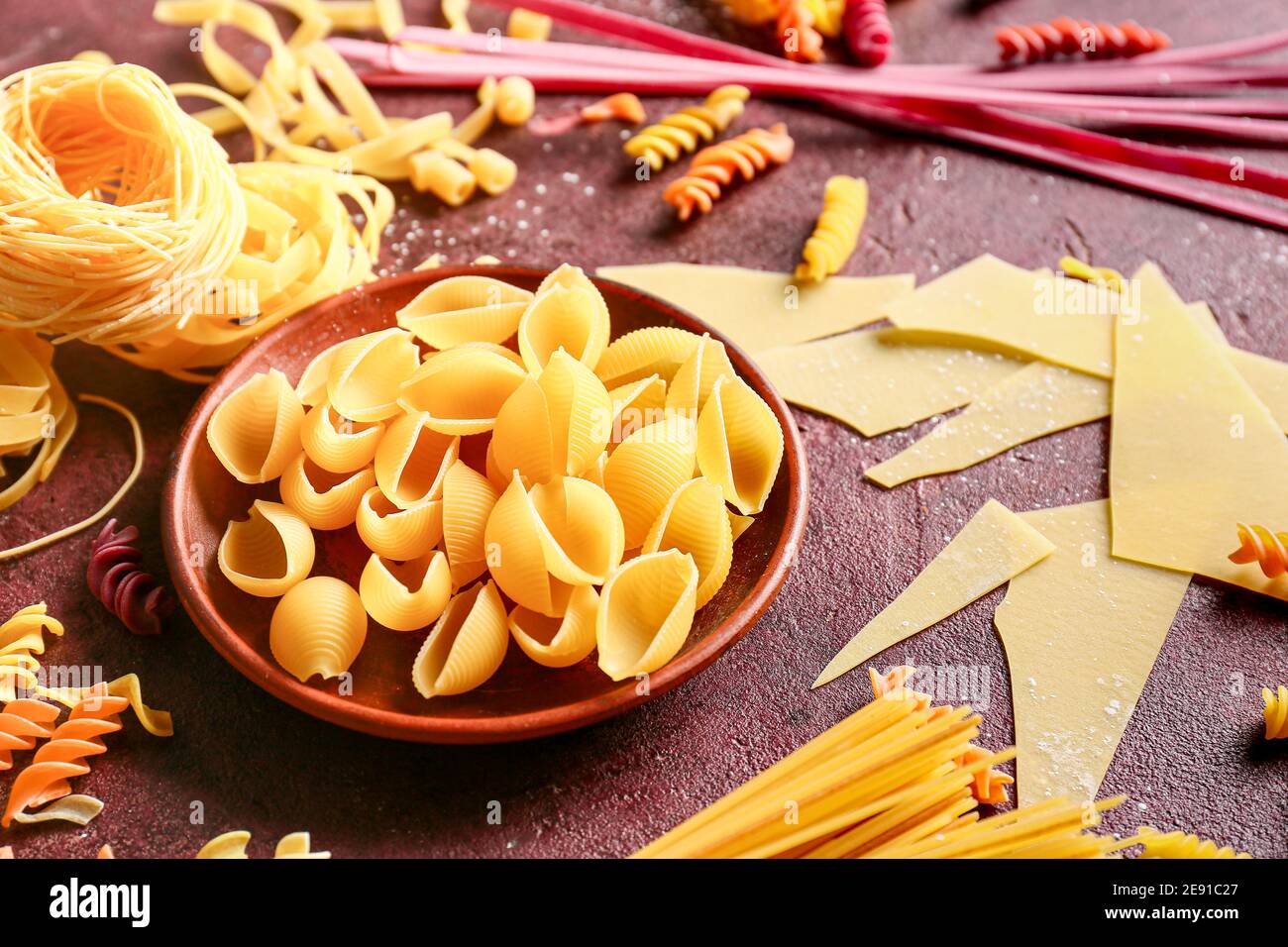 Assortment of dry pasta on color background Stock Photo - Alamy