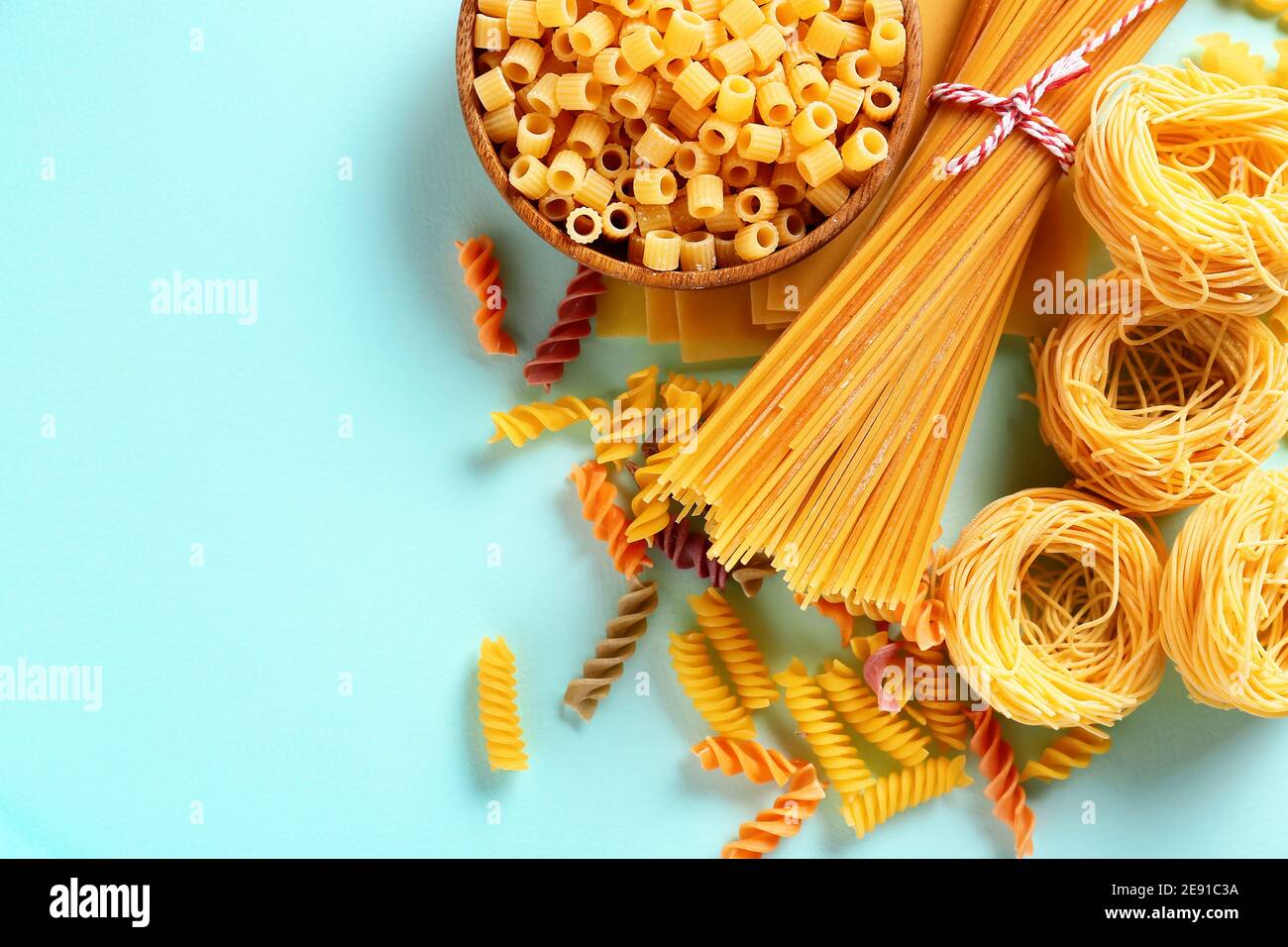 Assortment of dry pasta on color background Stock Photo - Alamy