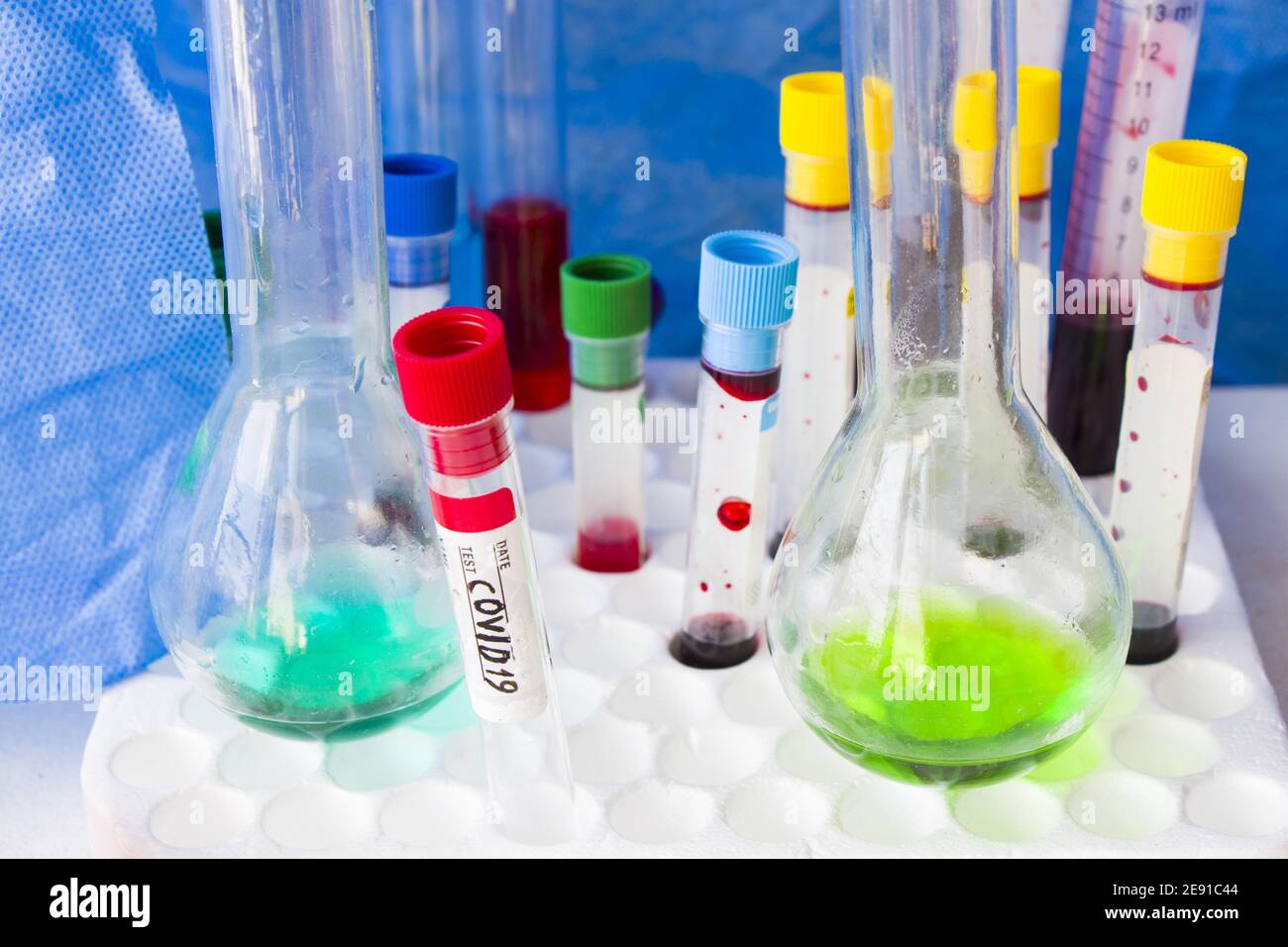 Set of laboratory instruments with glassware, reagents, and colorful ...