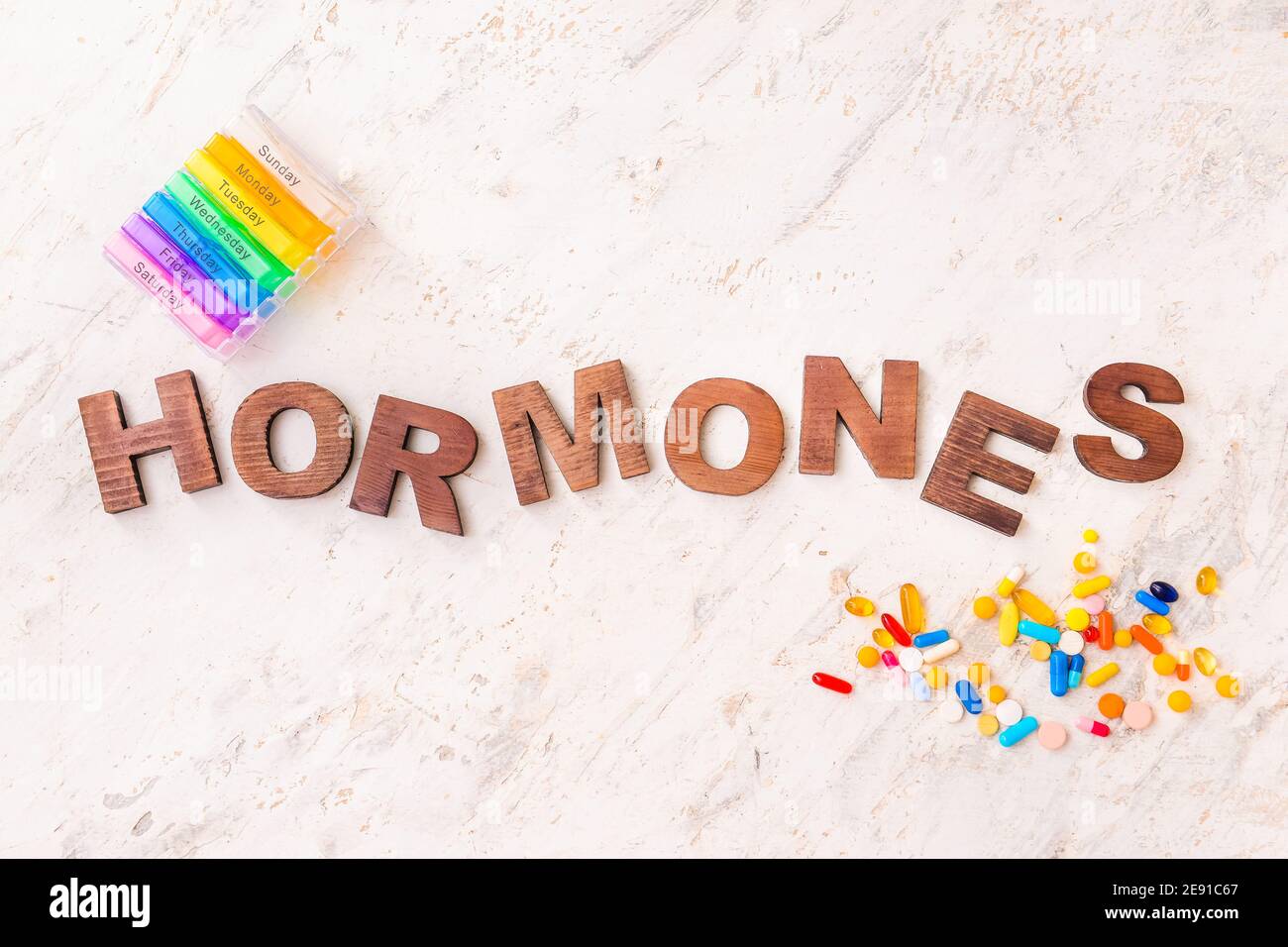 Word HORMONES and pills on white background Stock Photo - Alamy