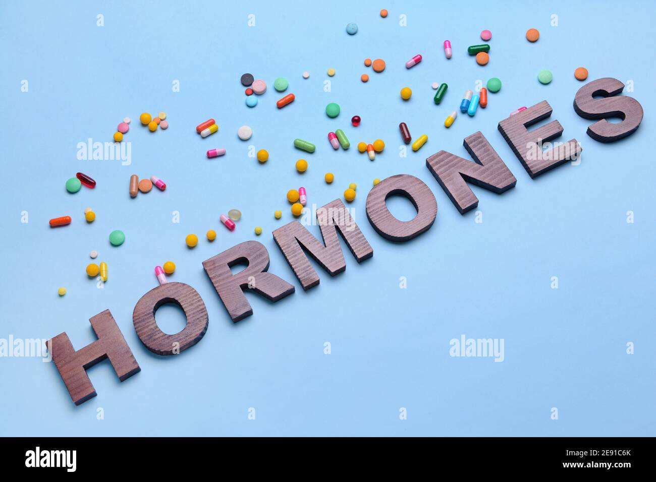 Word HORMONES and pills on color background Stock Photo - Alamy