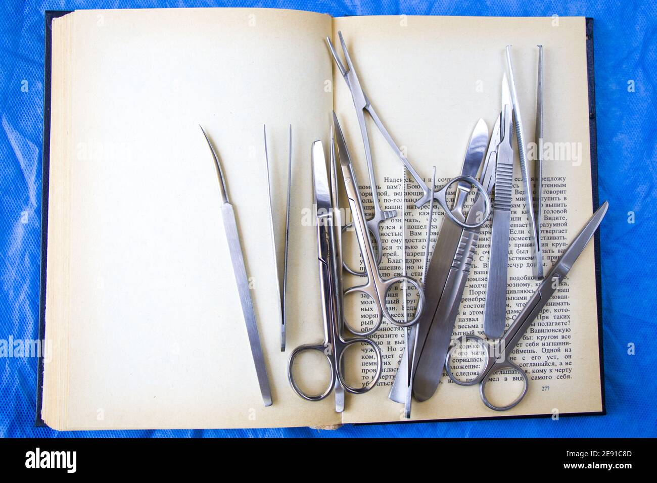 Top view of a set of stainless dissecting kits on an open book Stock ...