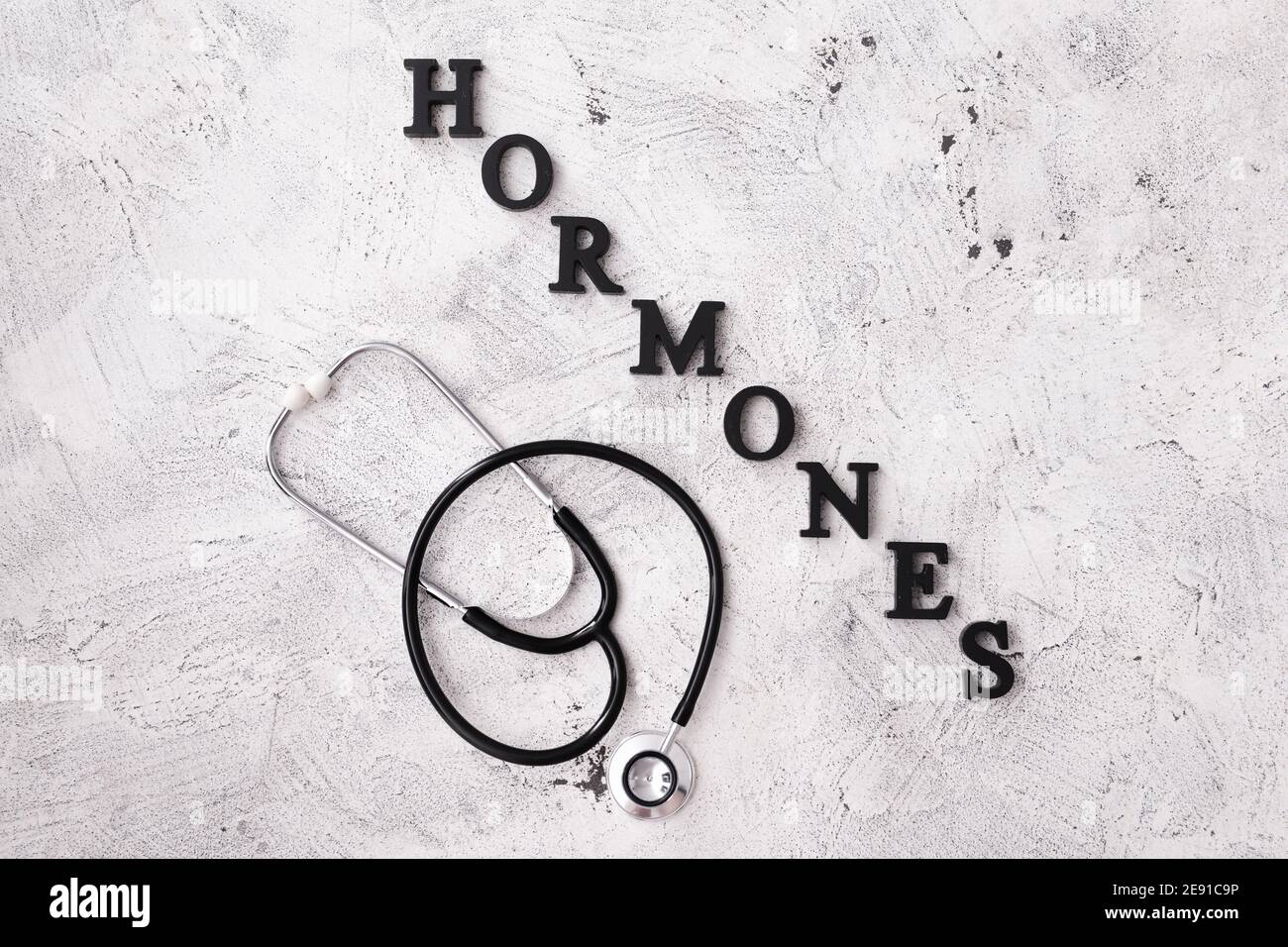 Word HORMONES and stethoscope on grey background Stock Photo - Alamy