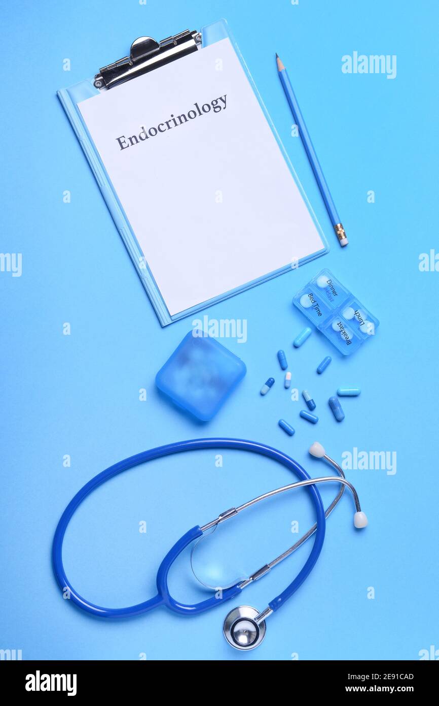 Clipboard with word ENDOCRINOLOGY, stethoscope and pills on color ...