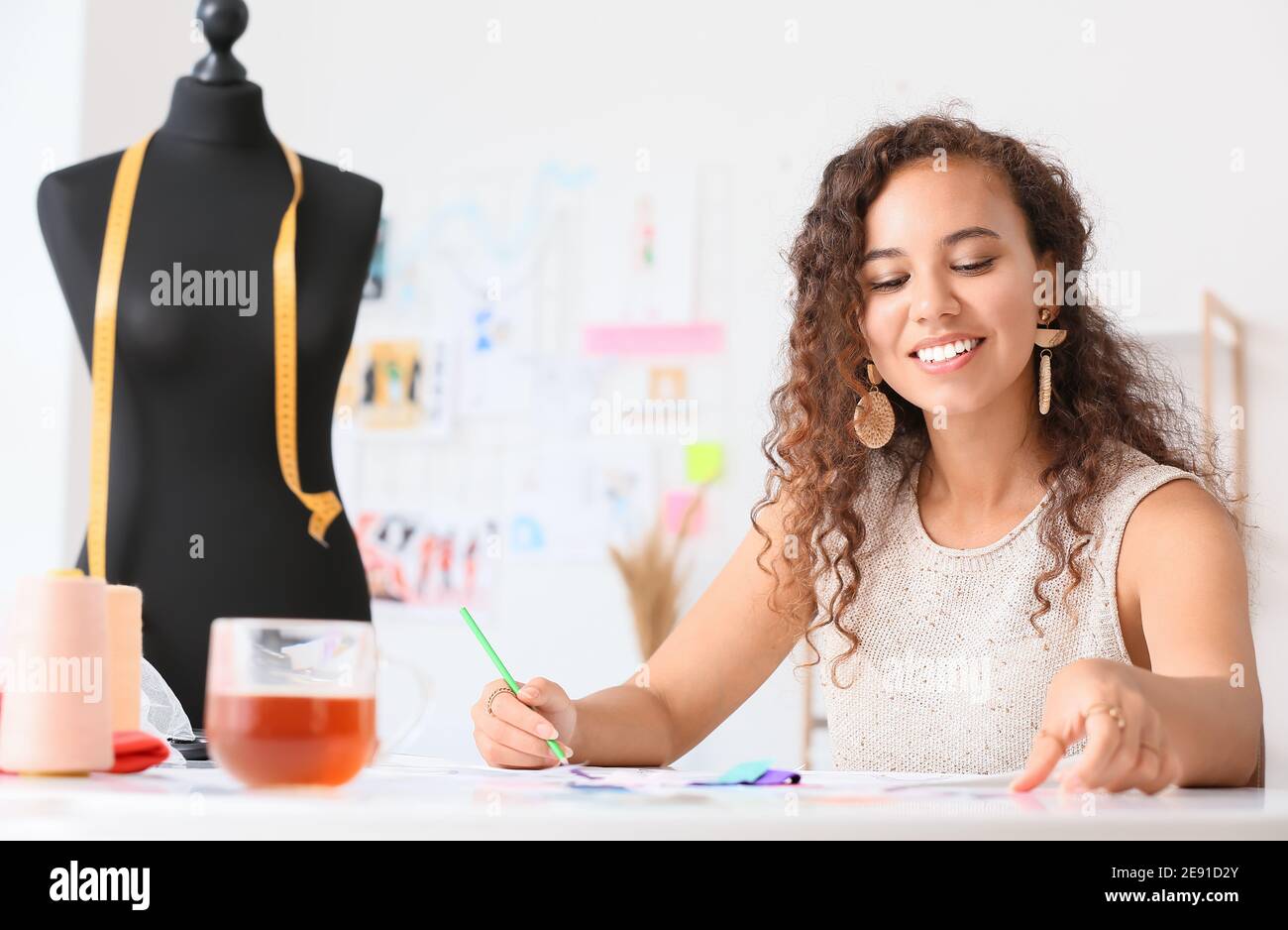 Female fashion designer working in studio Stock Photo - Alamy