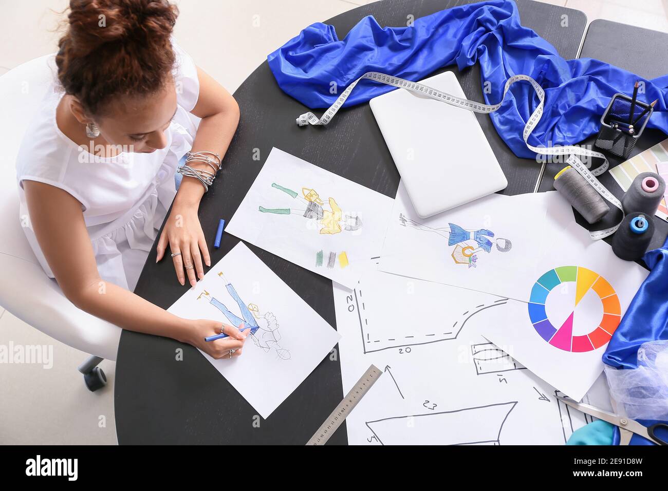 Female fashion designer working in studio Stock Photo - Alamy