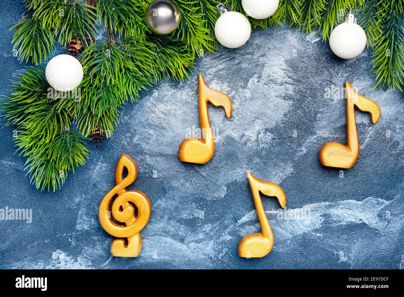 Music notes and Christmas decor on color background Stock Photo - Alamy