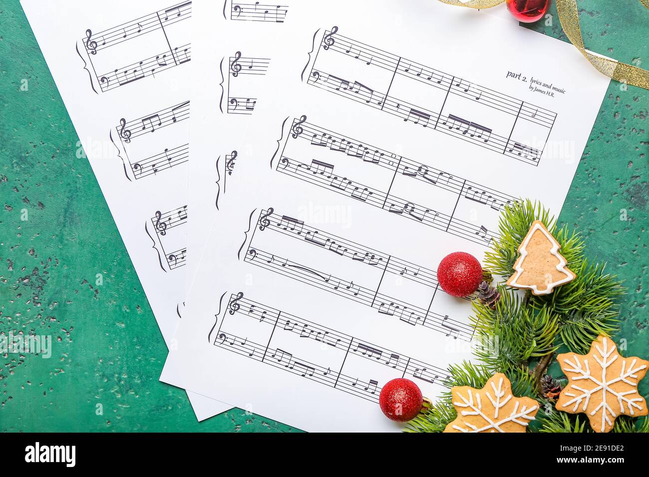 Music sheets with notes and Christmas decor on color background Stock ...