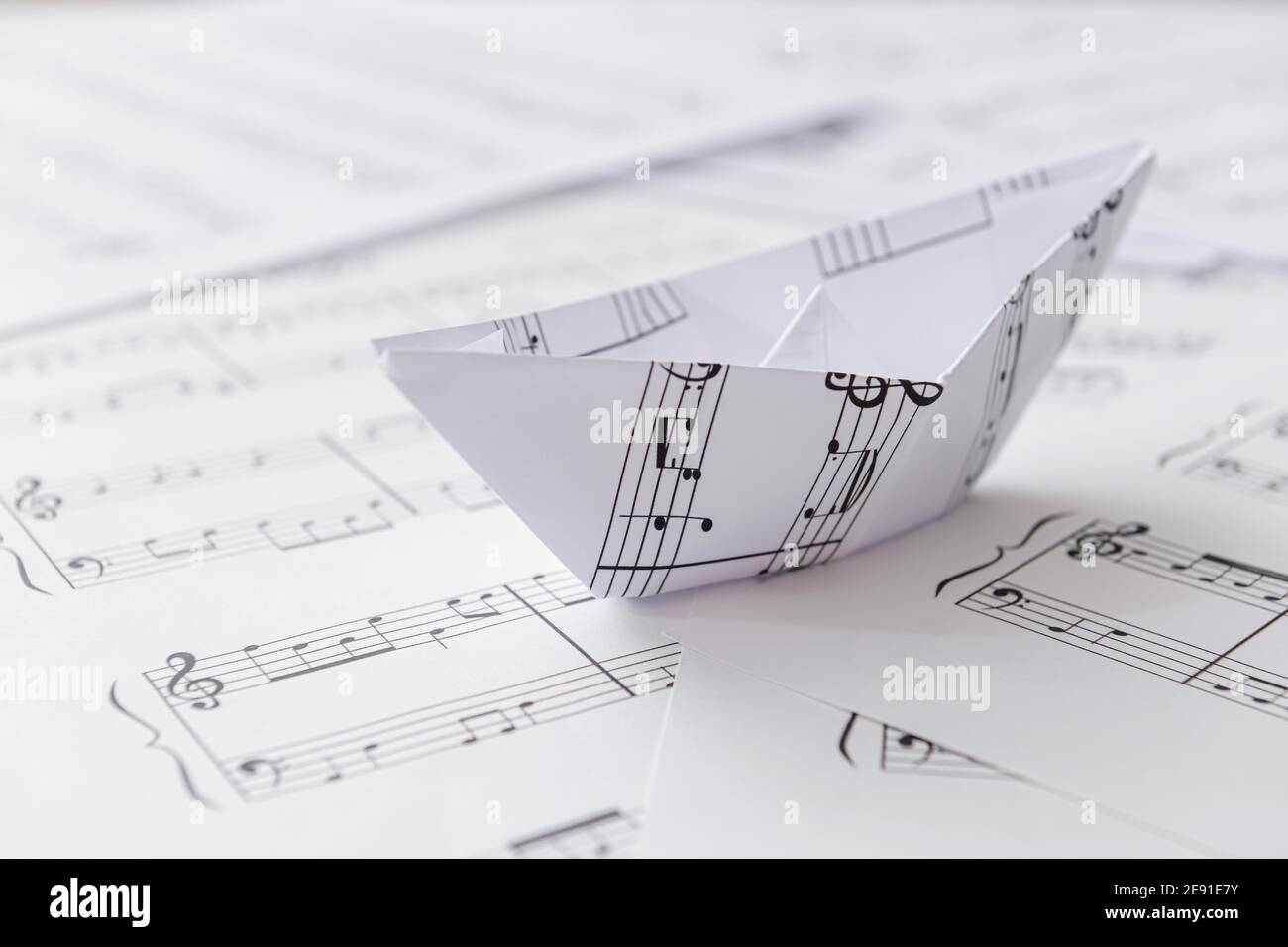 Paper boat with notes on music sheets Stock Photo - Alamy