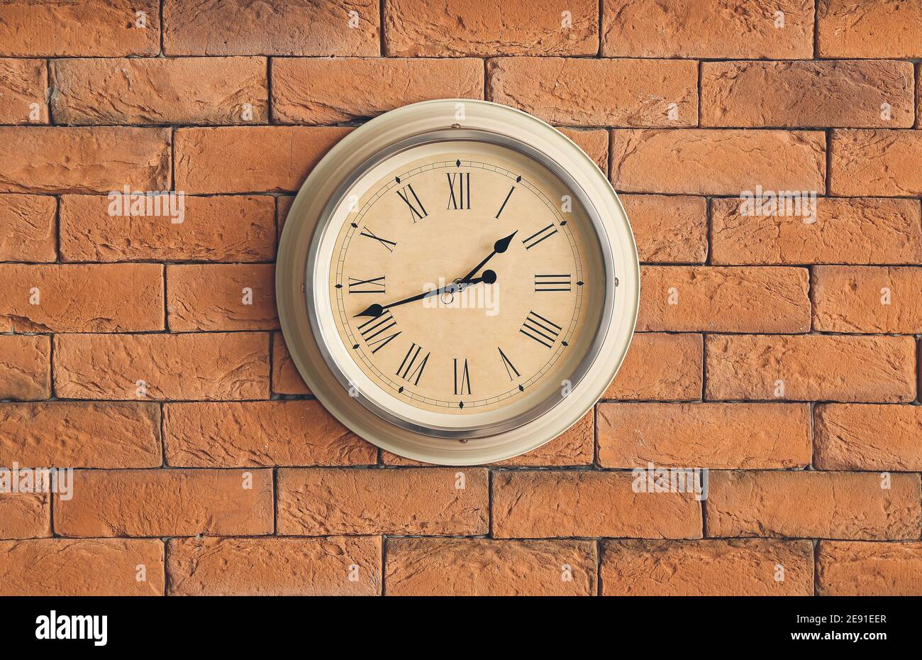 Clock hanging on brick wall hi-res stock photography and images - Alamy