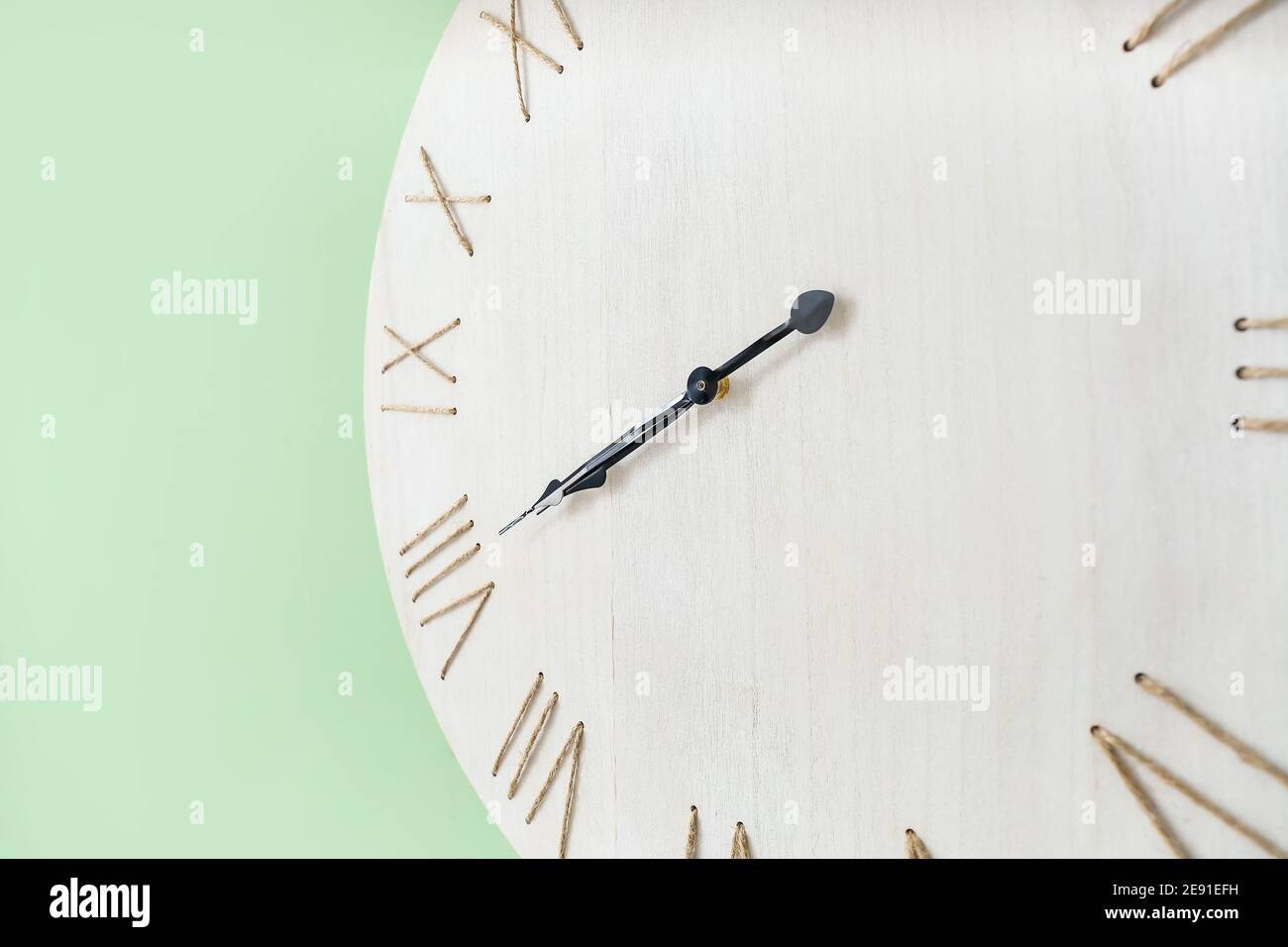 Modern clock hanging on color wall Stock Photo - Alamy