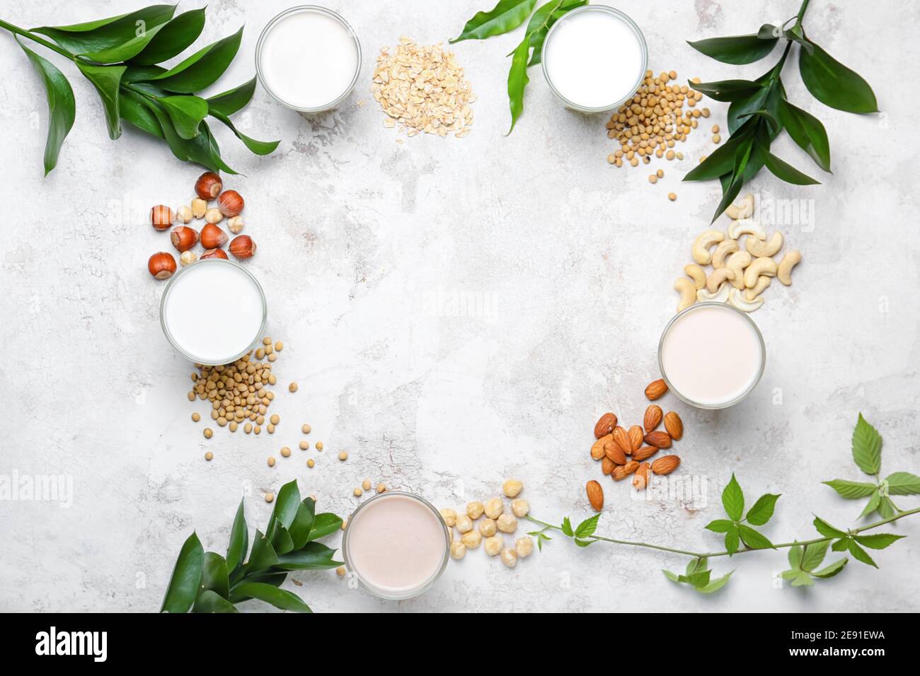 Frame made of glasses with different vegan milk on light background ...