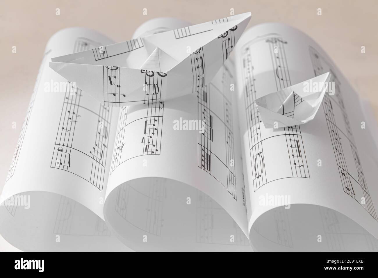 Paper boat with notes on rolled music sheets Stock Photo - Alamy