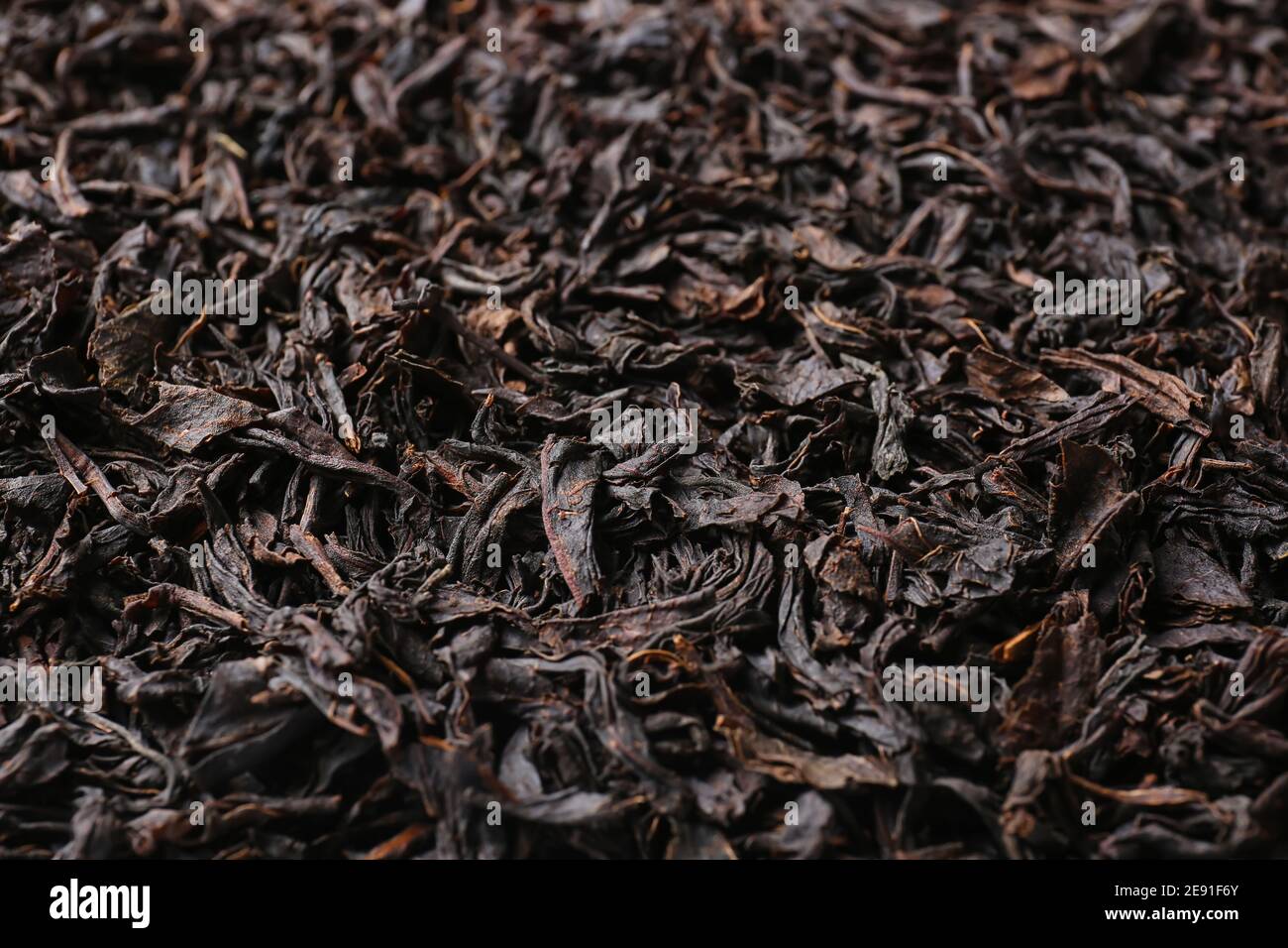 Dry black tea leaves as background Stock Photo - Alamy