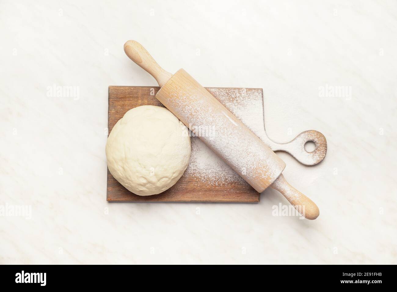 Fresh dough and rolling pin on white background Stock Photo - Alamy