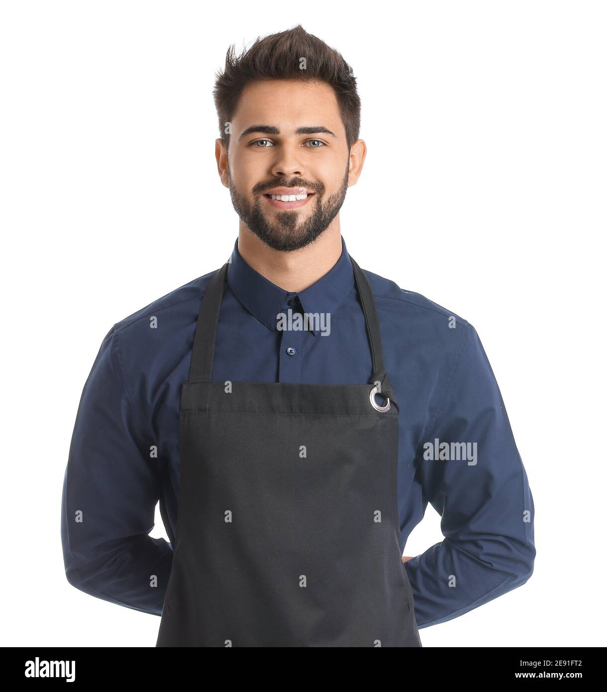 Young man wearing apron on white background Stock Photo - Alamy