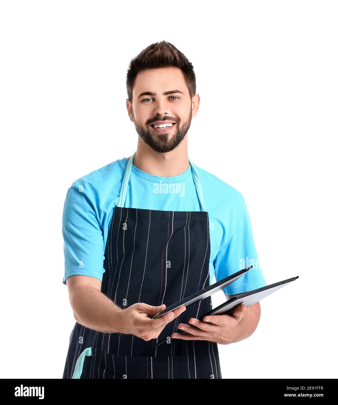 Young waiter holding menu on white background Stock Photo - Alamy