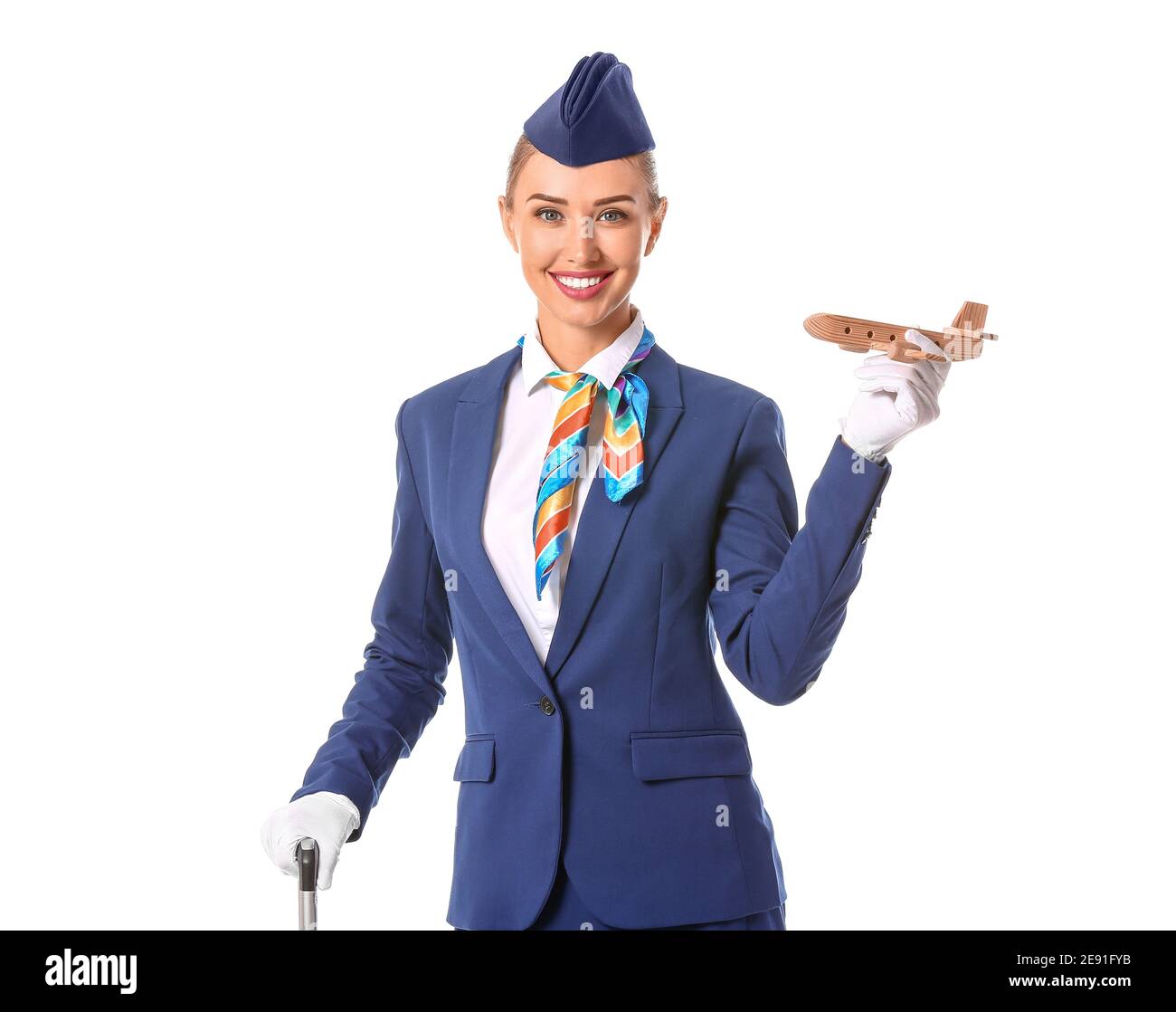 Beautiful stewardess with suitcase and wooden plane on white background ...