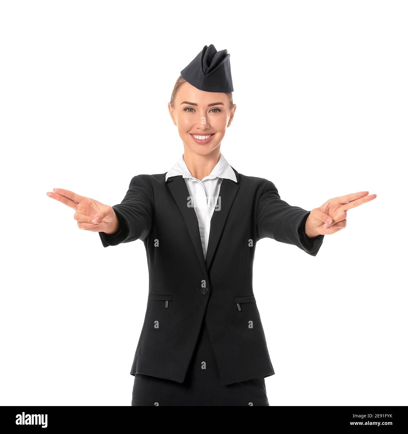 Beautiful stewardess showing something on white background Stock Photo ...