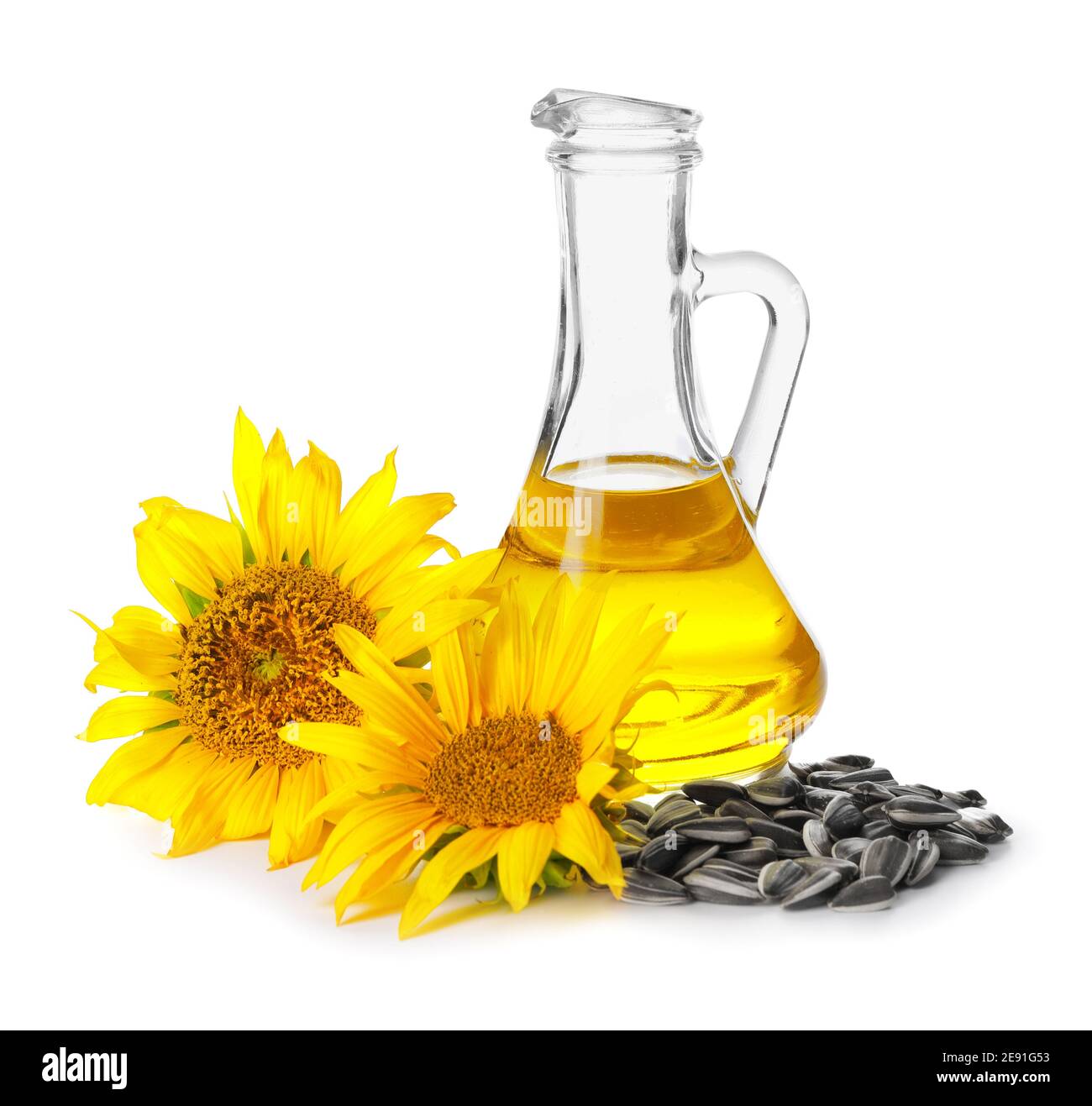 Jug of oil, seeds and sunflowers on white background Stock Photo - Alamy