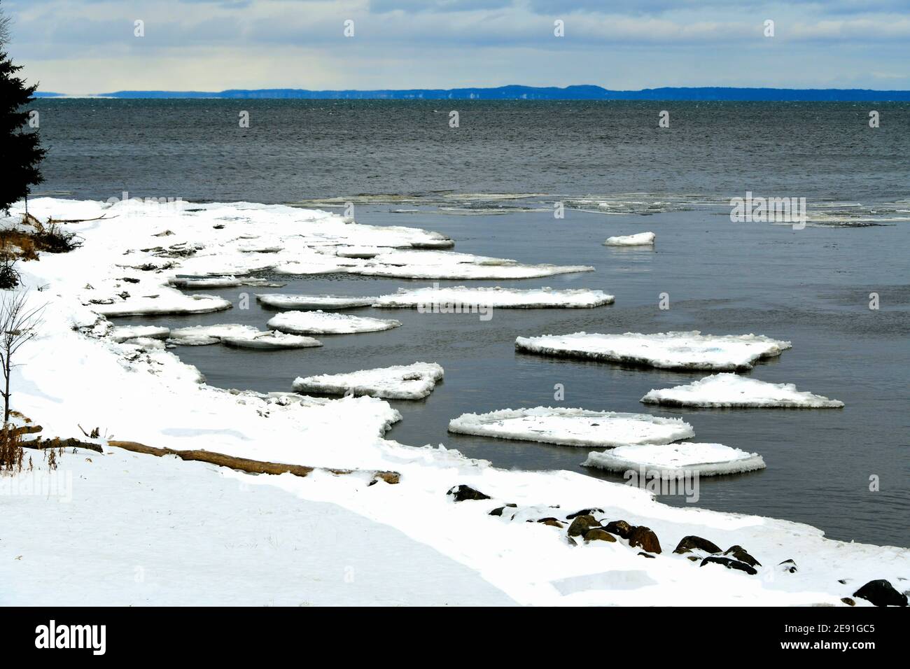Blocks of ice and snow floating in the water off the Canadian shoreline ...