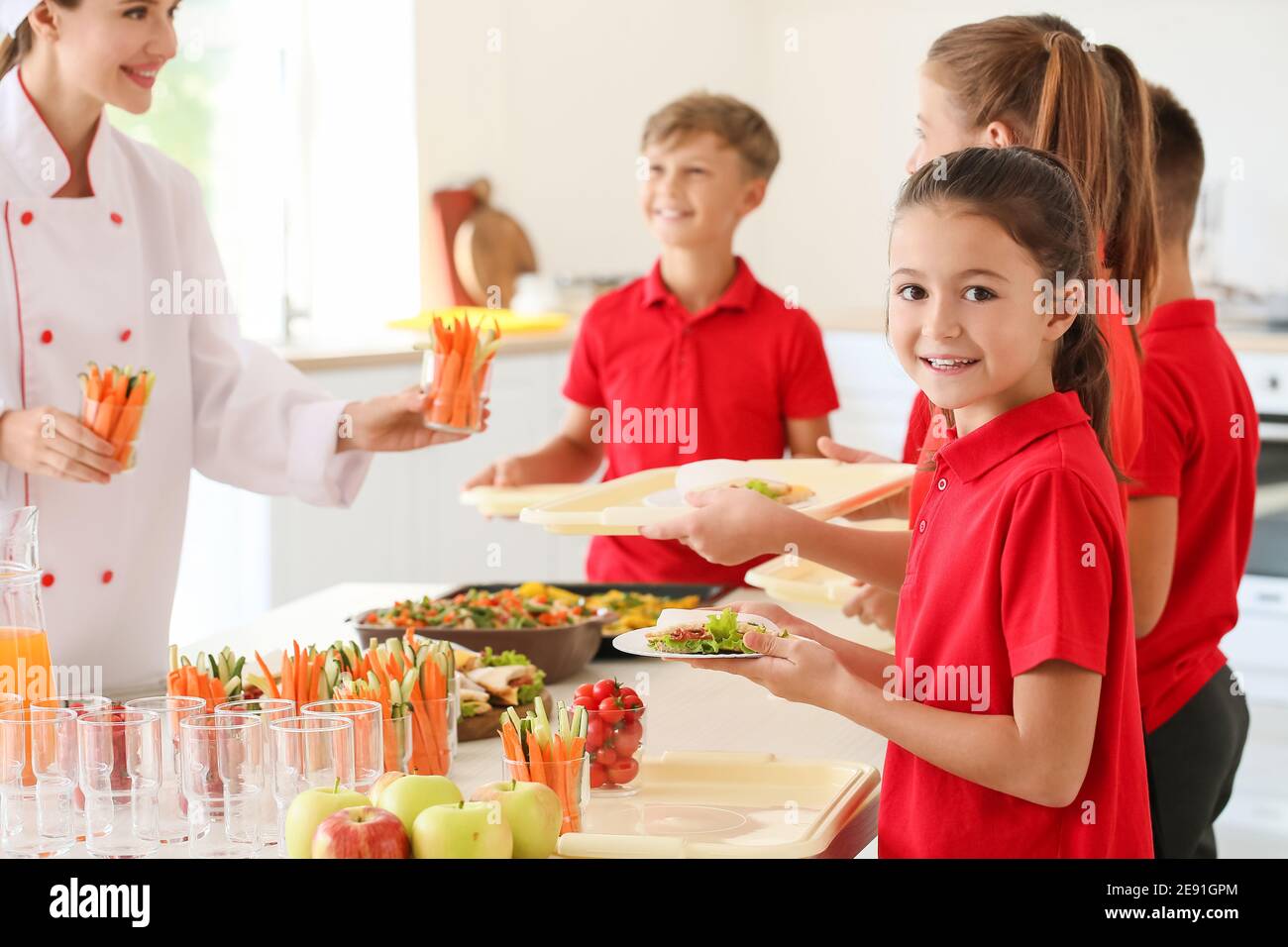 Pupils receiving lunch in school canteen Stock Photo - Alamy