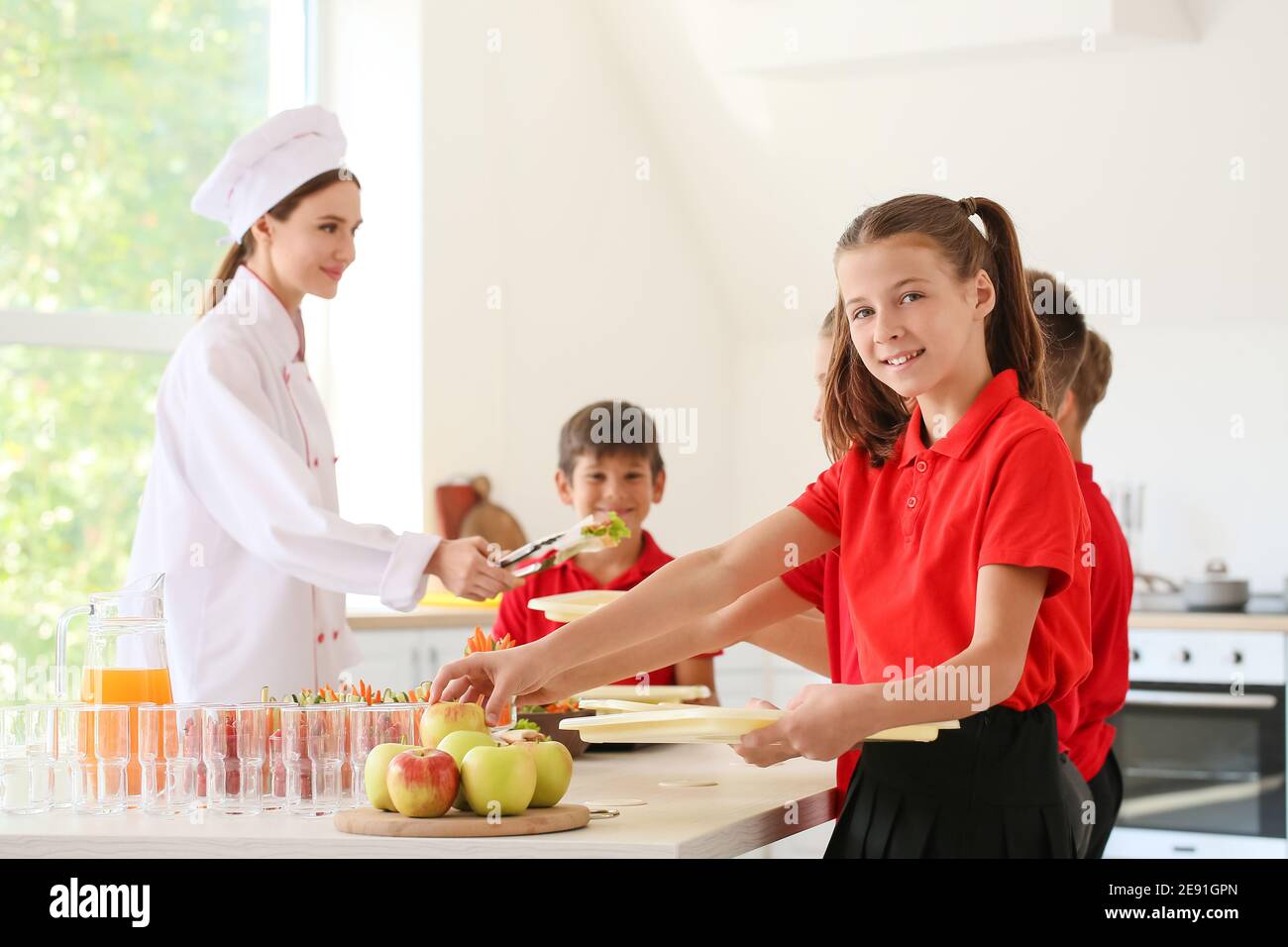 Pupils receiving lunch in school canteen Stock Photo - Alamy