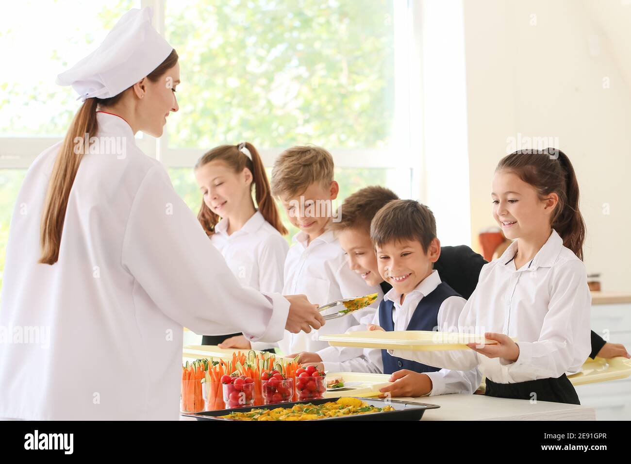 Pupils receiving lunch in school canteen Stock Photo - Alamy