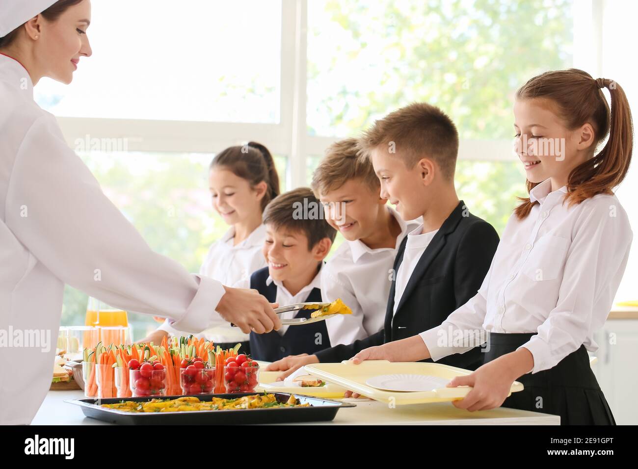 Pupils receiving lunch in school canteen Stock Photo - Alamy