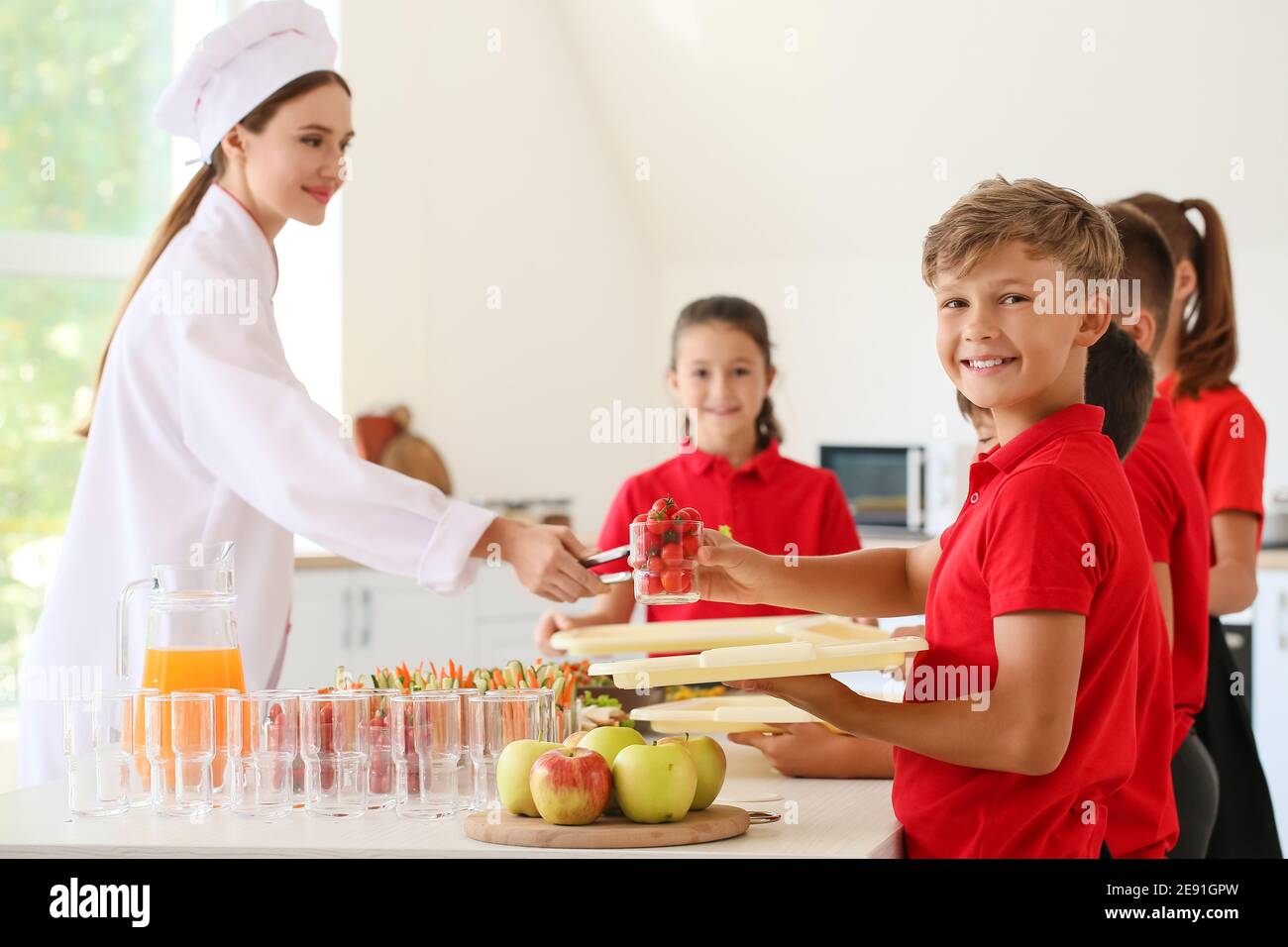 Pupils receiving lunch in school canteen Stock Photo - Alamy