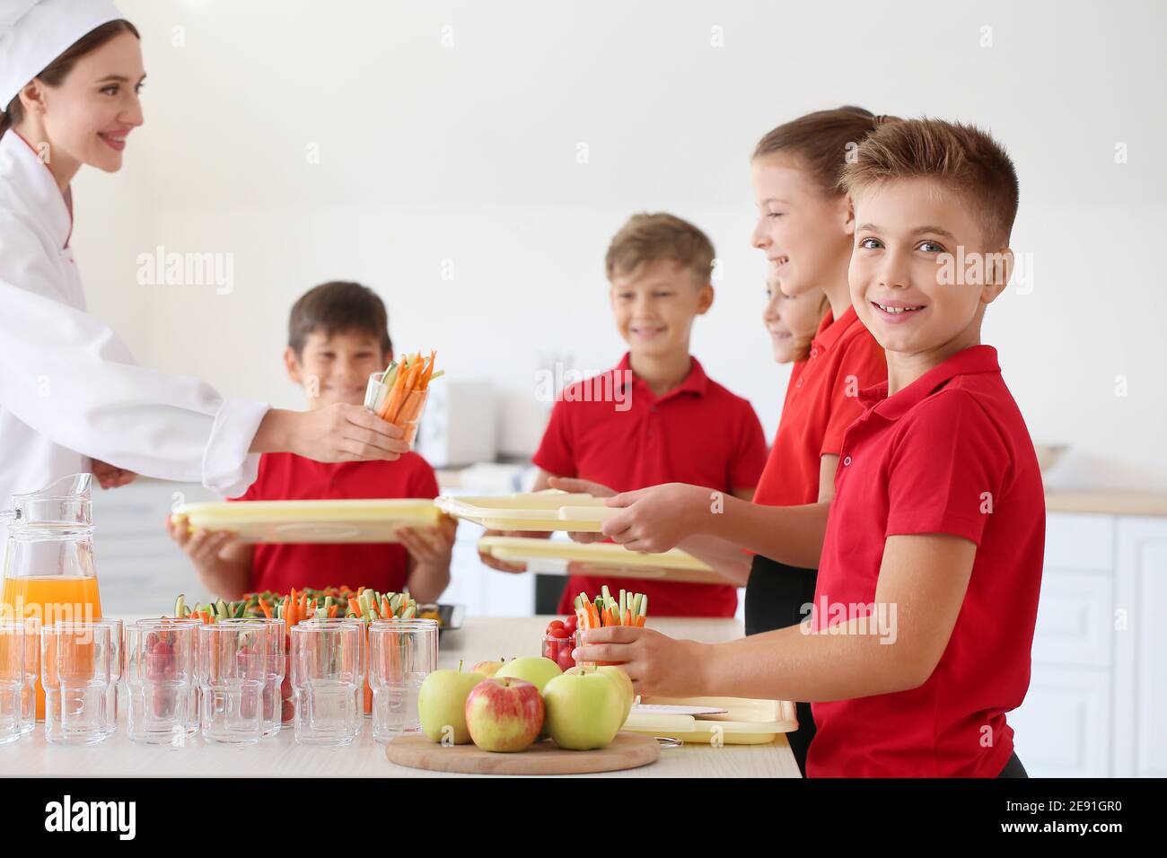 Pupils receiving lunch in school canteen Stock Photo - Alamy