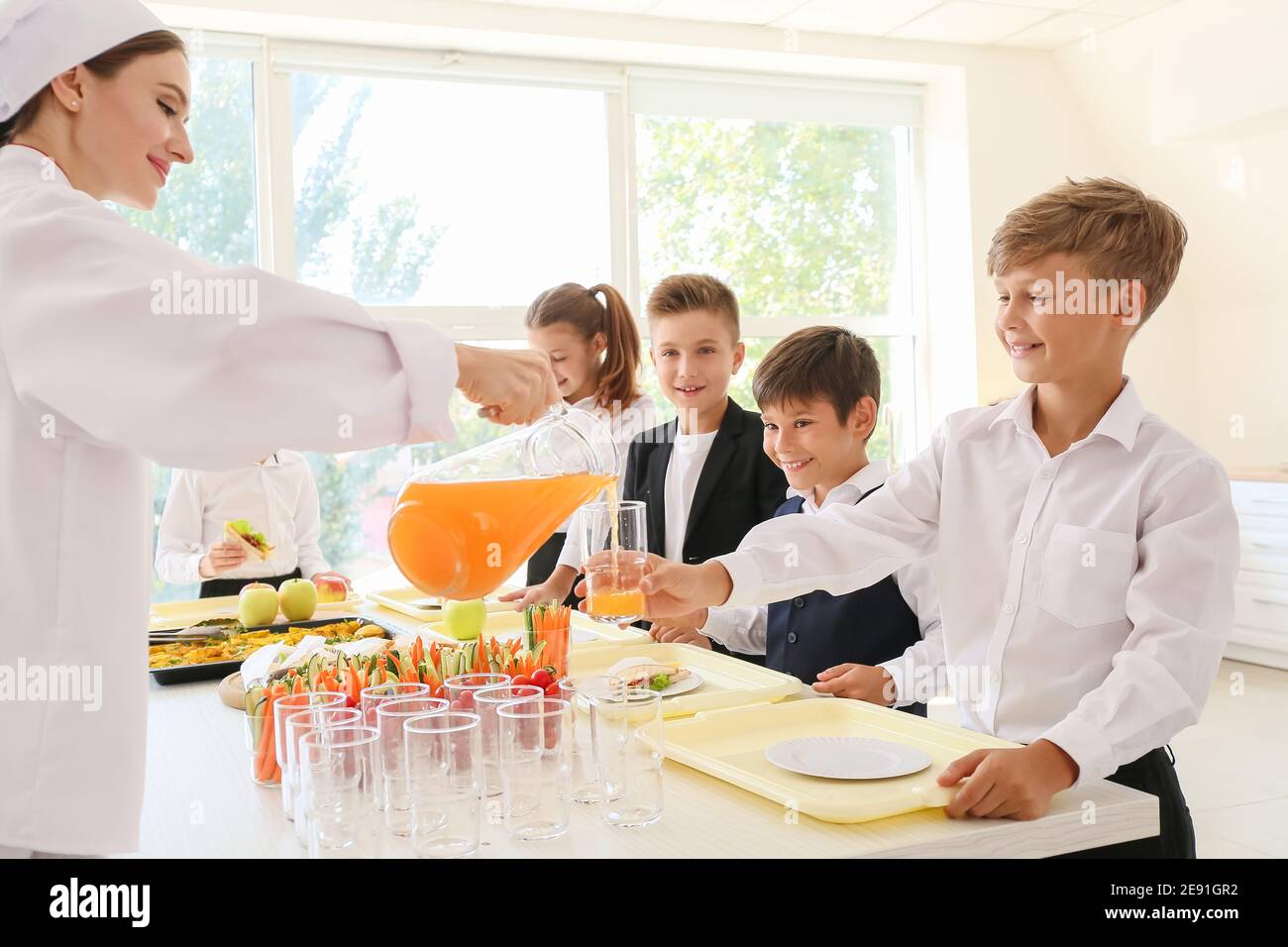 Pupils receiving lunch in school canteen Stock Photo - Alamy