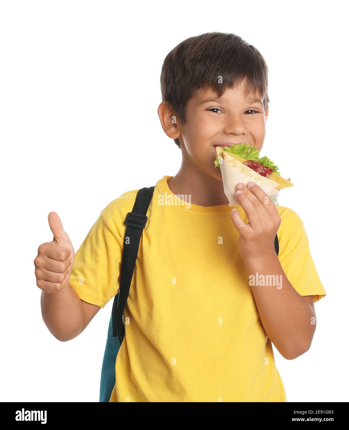 Schoolboy eating sandwich on white background Stock Photo - Alamy