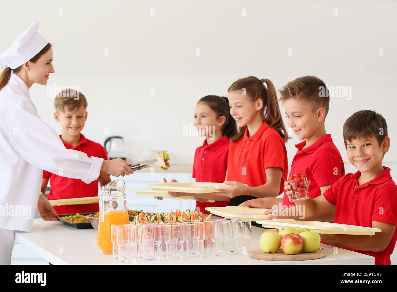 Pupils receiving lunch in school canteen Stock Photo - Alamy