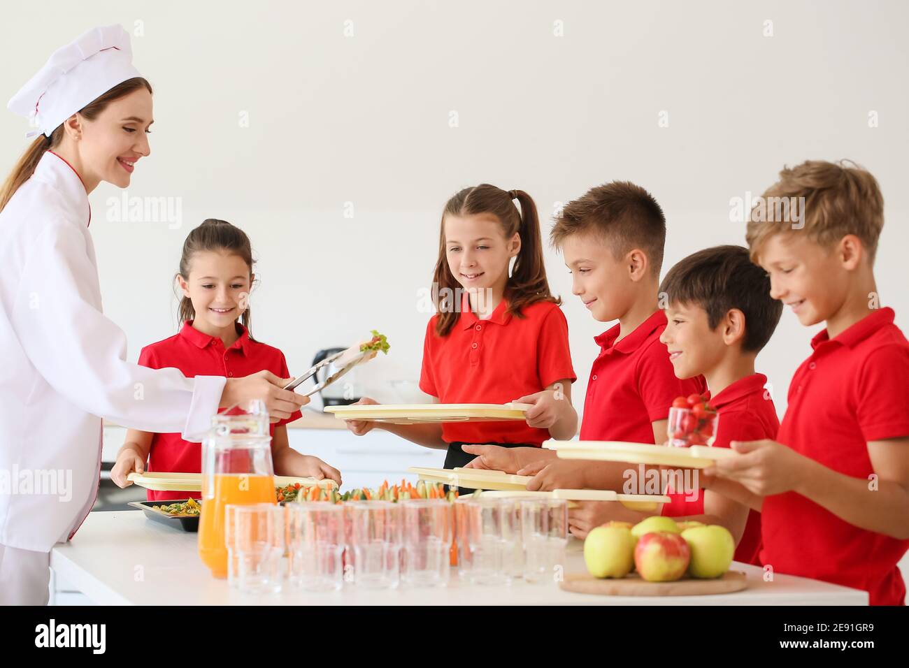 Pupils receiving lunch in school canteen Stock Photo - Alamy
