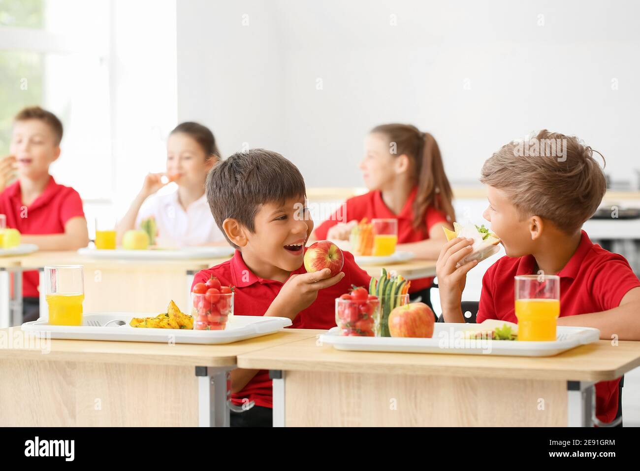 Pupils having healthy lunch in classroom Stock Photo - Alamy