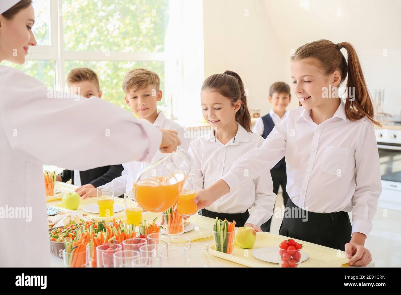 Pupils receiving lunch in school canteen Stock Photo - Alamy