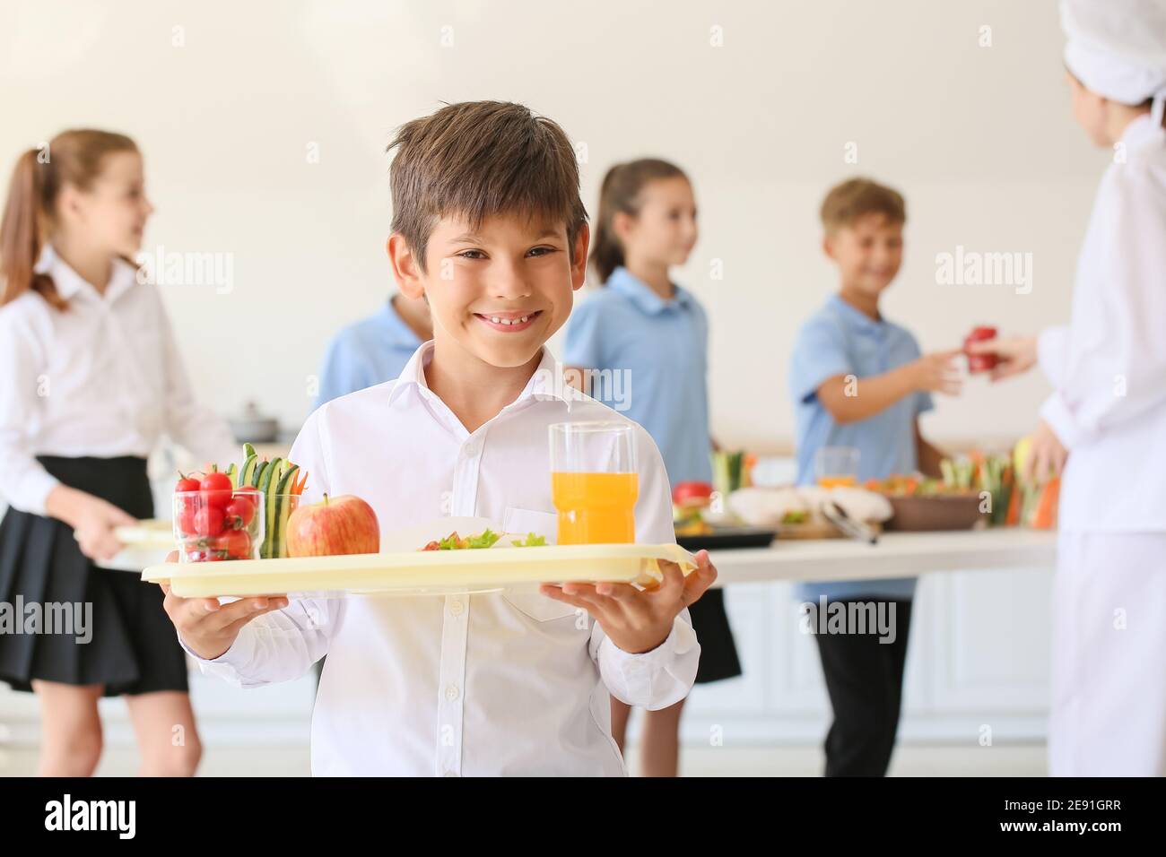 Schoolboy having lunch in school canteen Stock Photo - Alamy