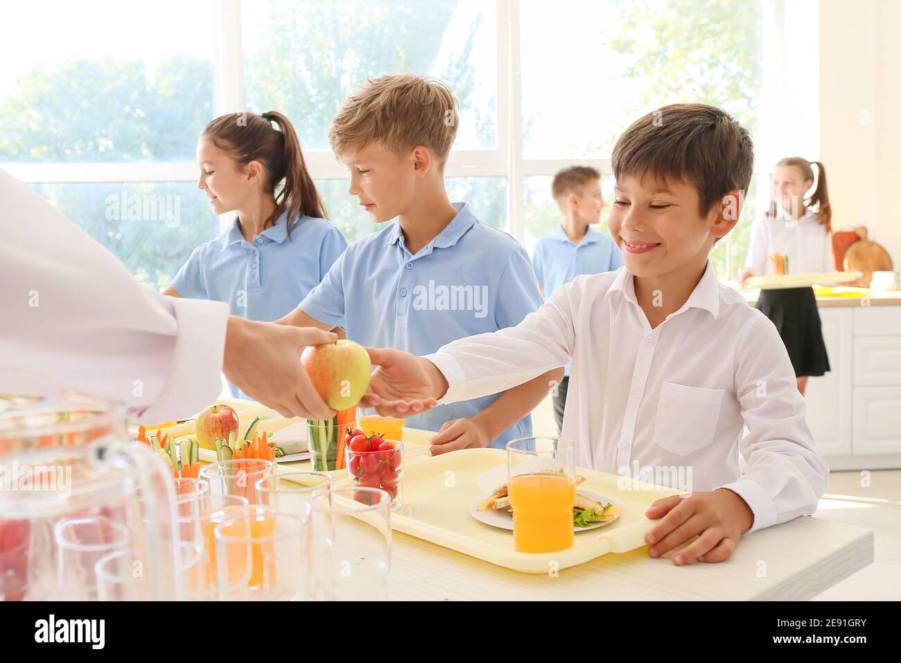Pupils receiving lunch in school canteen Stock Photo - Alamy