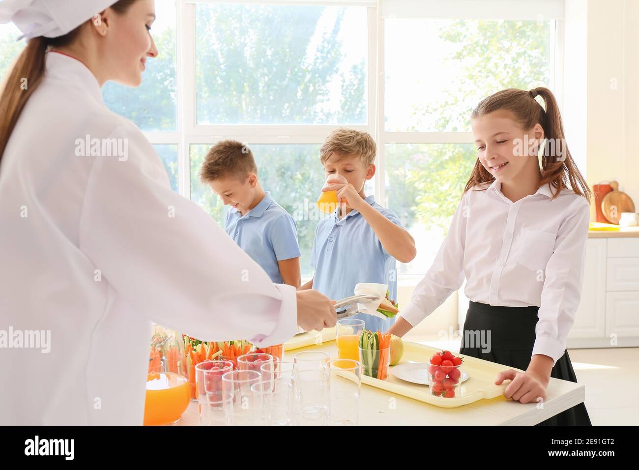 Pupils receiving lunch in school canteen Stock Photo - Alamy