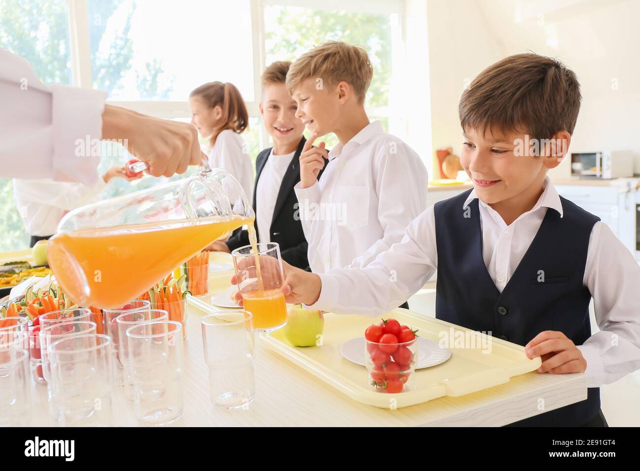 Pupils receiving lunch in school canteen Stock Photo - Alamy