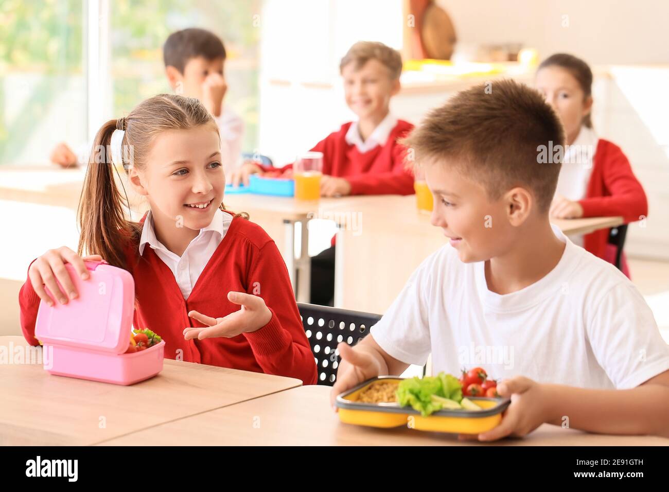 Pupils having healthy lunch in classroom Stock Photo - Alamy