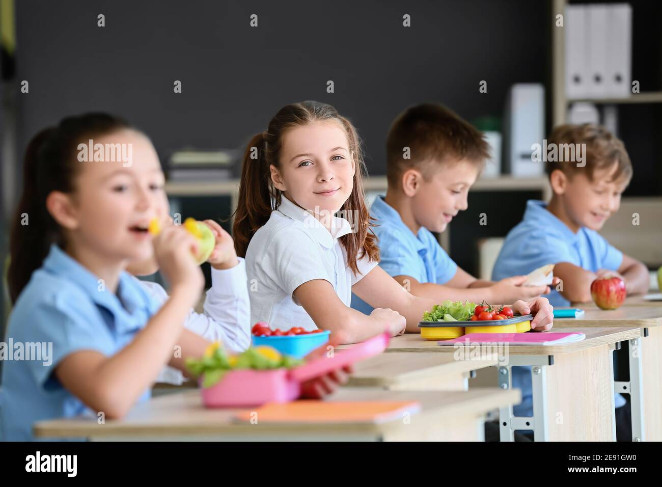 Pupils having healthy lunch in classroom Stock Photo - Alamy